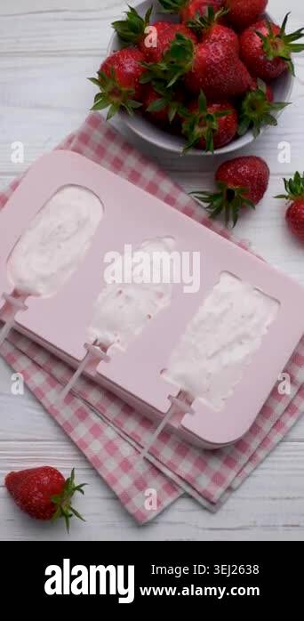Pink silicone mold filled with creamy strawberry ice cream and fresh ...