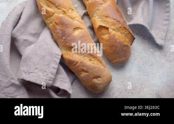 Freshly baked french baguettes resting on linen Stock Video Footage - Alamy