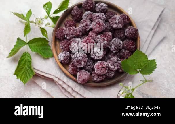 Frozen blackberries with green leaves and flowers Stock Video Footage ...