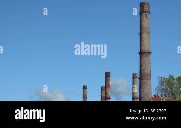 Static shot of industrial chimneys without smoke against clear blue sky ...