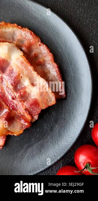 Fried fresh bacon slices with layers of meat or prosciutto with salt ...