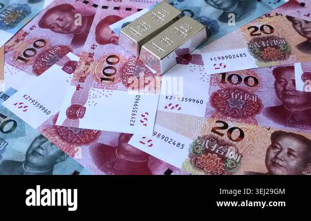 A silver bar, white metal against a backdrop of Chinese money, as a ...