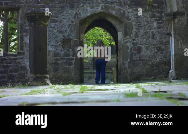 Woman tourist stands in archway of Saint Thomas a Becket Abbey Church ...