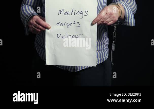Employee in handcuffs looking at busy schedule black background medium ...