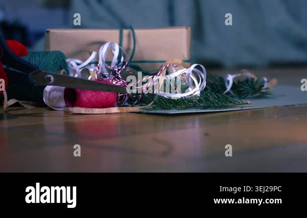 Hands with Christmas gift wrapping ribbon and string green background ...