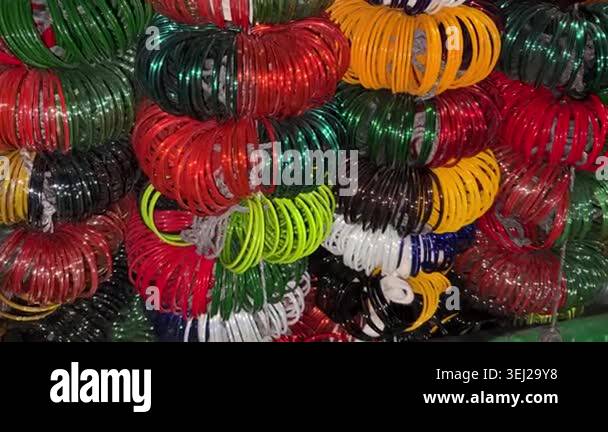 stacked colorful glass bangles in marketplace for festive shopping ...