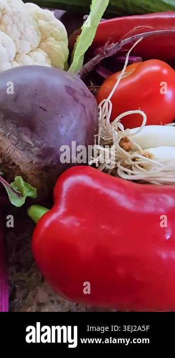 a fresh assortment of vegetables including cauliflower, tomatoes, red ...