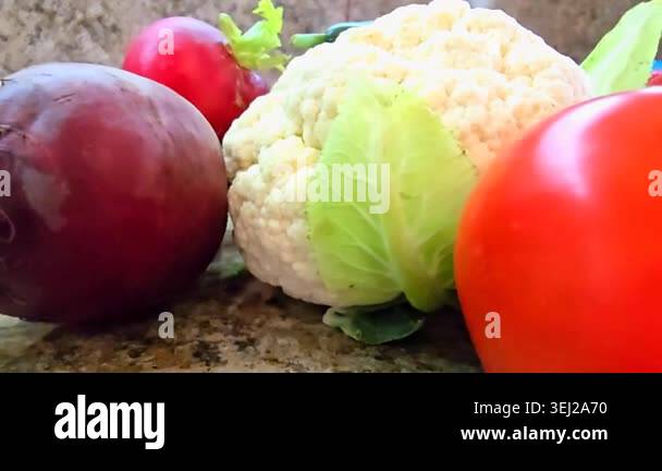 a fresh assortment of vegetables including cauliflower, tomatoes, red ...