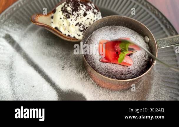 Close up of spoon dipping into warm chocolate lava cake with molten ...