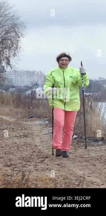 Two elderly woman in autumn park have modern healthy training - nordic ...
