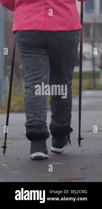 Nordic walking - sport for elderly woman in autumn park - modern ...