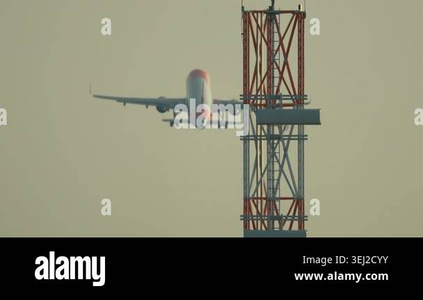 A plane is seen approaching its landing at an airport near a radio ...