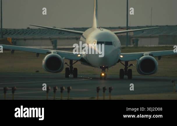 An aircraft approaches the runway for landing at an airport during ...