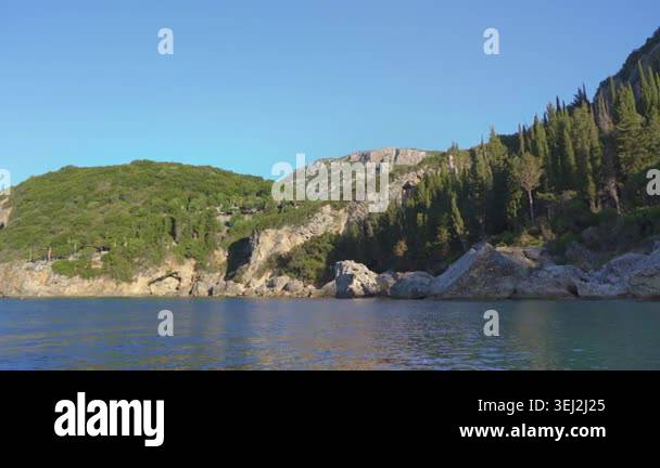 Calm morning sea near rough sand beach at Liapades Corfu, Greece - sun ...