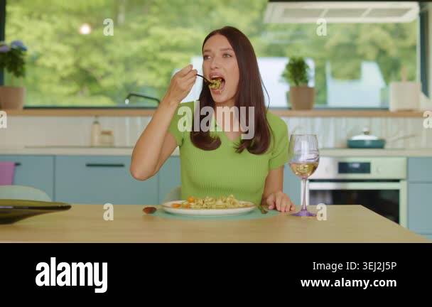 Static portrait shot of a young woman tasting and eating fresh homemade ...