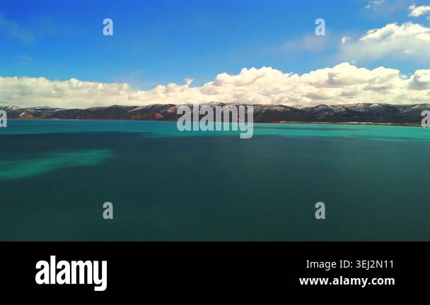 Aerial drone flight over Bear Lake with layered turquoise water and ...