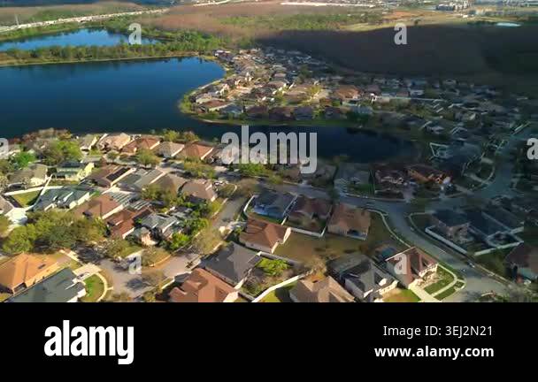 Sideways drone flyover above suburban Orlando homes as cloud shadows ...