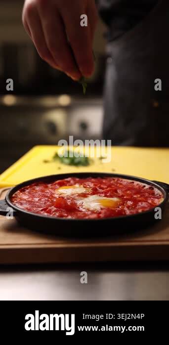 A professional chef prepares delicious fresh breakfast dishes in a ...