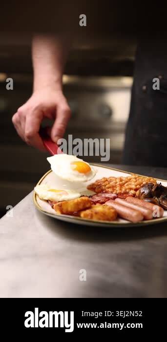 A professional chef prepares delicious fresh breakfast dishes in a ...
