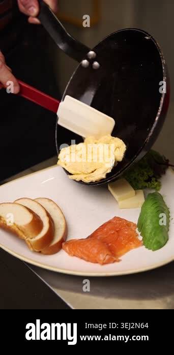 A professional chef prepares delicious fresh breakfast dishes in a ...