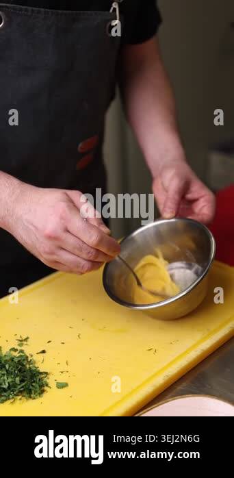 A professional chef prepares delicious fresh breakfast dishes in a ...