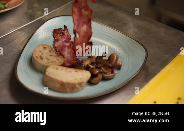 A professional chef prepares delicious fresh breakfast dishes in a ...