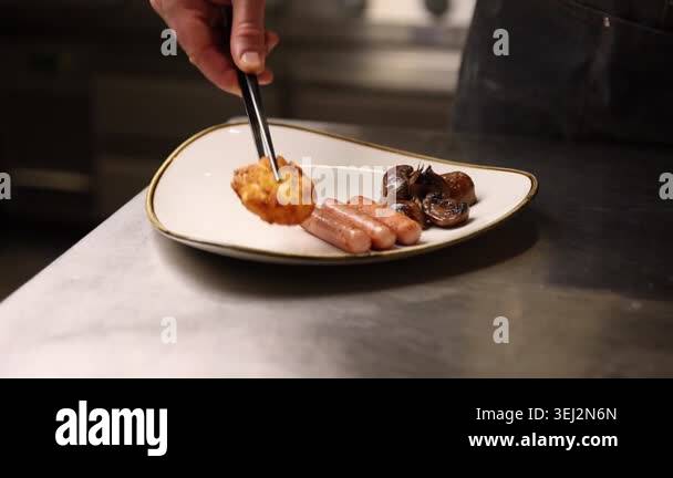 A professional chef prepares delicious fresh breakfast dishes in a ...