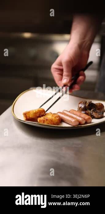 A professional chef prepares delicious fresh breakfast dishes in a ...