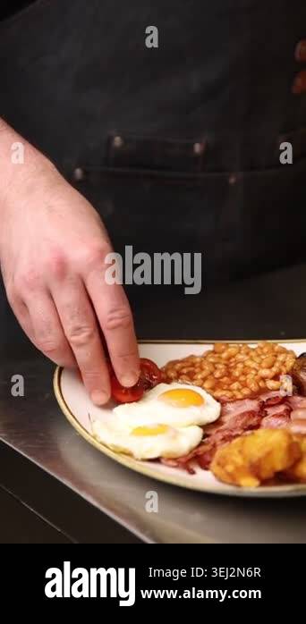 A professional chef prepares delicious fresh breakfast dishes in a ...