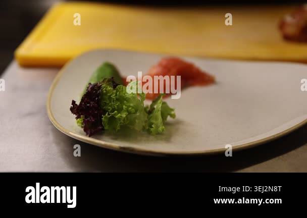 A professional chef prepares delicious fresh breakfast dishes in a ...