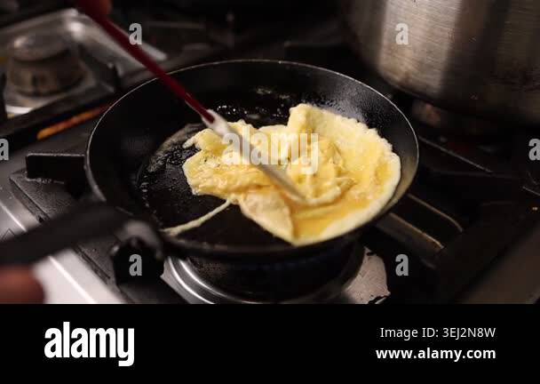 A professional chef prepares delicious fresh breakfast dishes in a ...