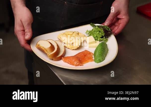 A professional chef prepares delicious fresh breakfast dishes in a ...