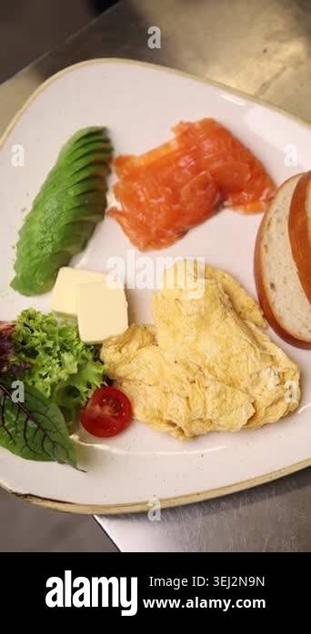 A professional chef prepares delicious fresh breakfast dishes in a ...