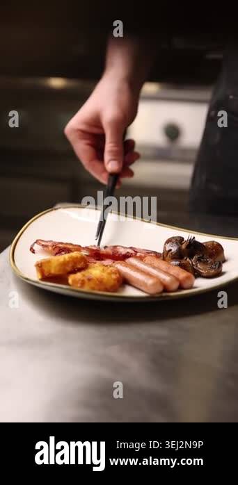 A professional chef prepares delicious fresh breakfast dishes in a ...