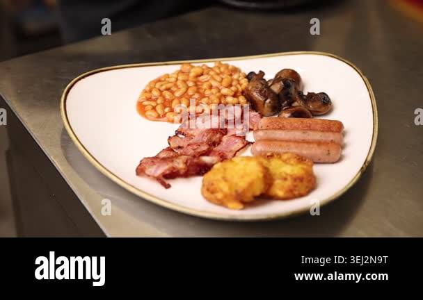A professional chef prepares delicious fresh breakfast dishes in a ...
