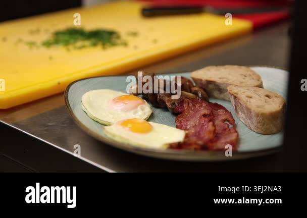 A professional chef prepares delicious fresh breakfast dishes in a ...