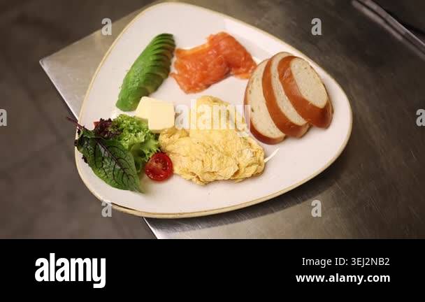 A professional chef prepares delicious fresh breakfast dishes in a ...