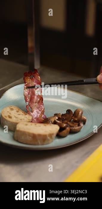 A professional chef prepares delicious fresh breakfast dishes in a ...