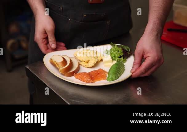 A professional chef prepares delicious fresh breakfast dishes in a ...