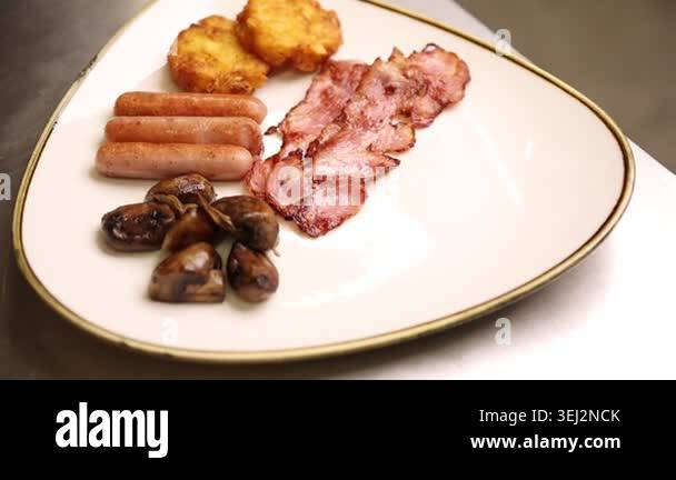 A professional chef prepares delicious fresh breakfast dishes in a ...