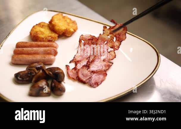 A professional chef prepares delicious fresh breakfast dishes in a ...