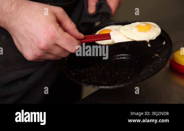 A professional chef prepares delicious fresh breakfast dishes in a ...