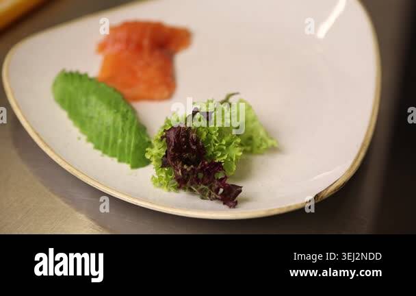 A professional chef prepares delicious fresh breakfast dishes in a ...