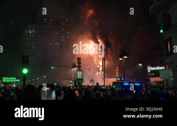 VALENCIA, SPAIN - MARCH 19, 2026: Green-lit scene as a large falla ...