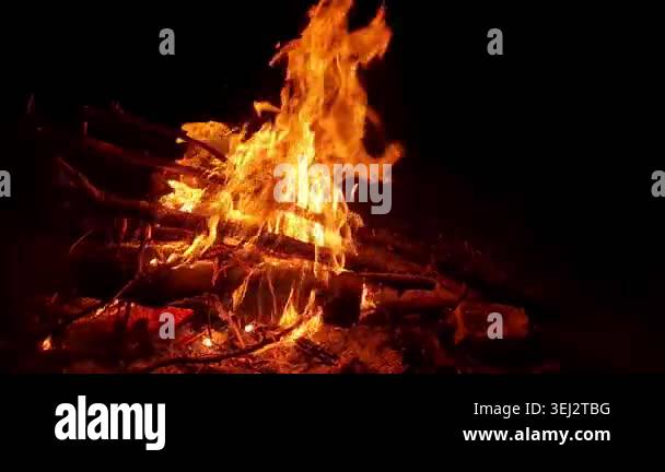 Burning bonfire with bright orange flames at night. Bonfire with sparks ...