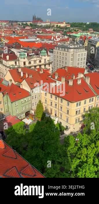 Bright view of Prague showing red rooftops and buildings with a ...