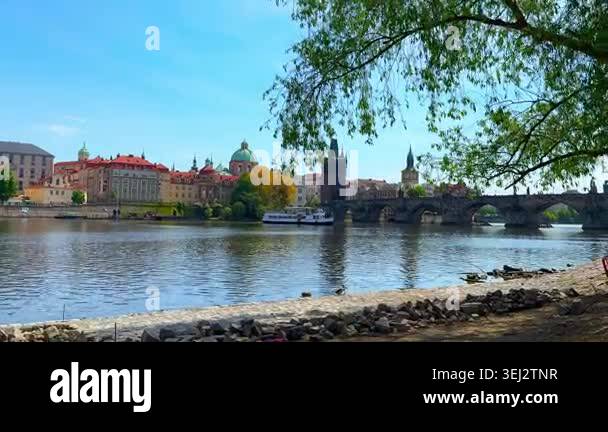 The Vltava River in Prague. The Charles Bridge stands tall in the ...