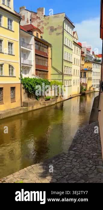 Canals flow between colorful buildings in Prague. Mala Strana or Lesser ...