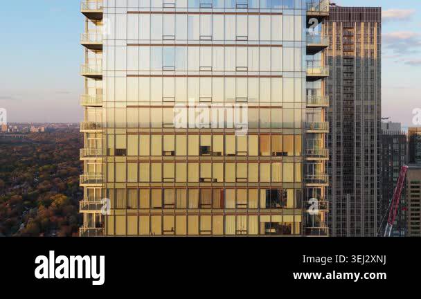 Golden hour sunbeam reflecting on modern glass facade skyscraper in ...