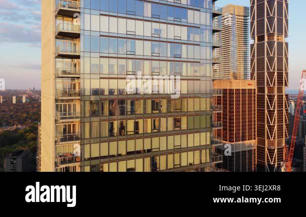 Modern residential tower facade with glass windows reflecting Toronto ...